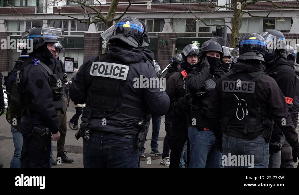 In slow motion a unit of plain clothes riot police wearing helmets and ...