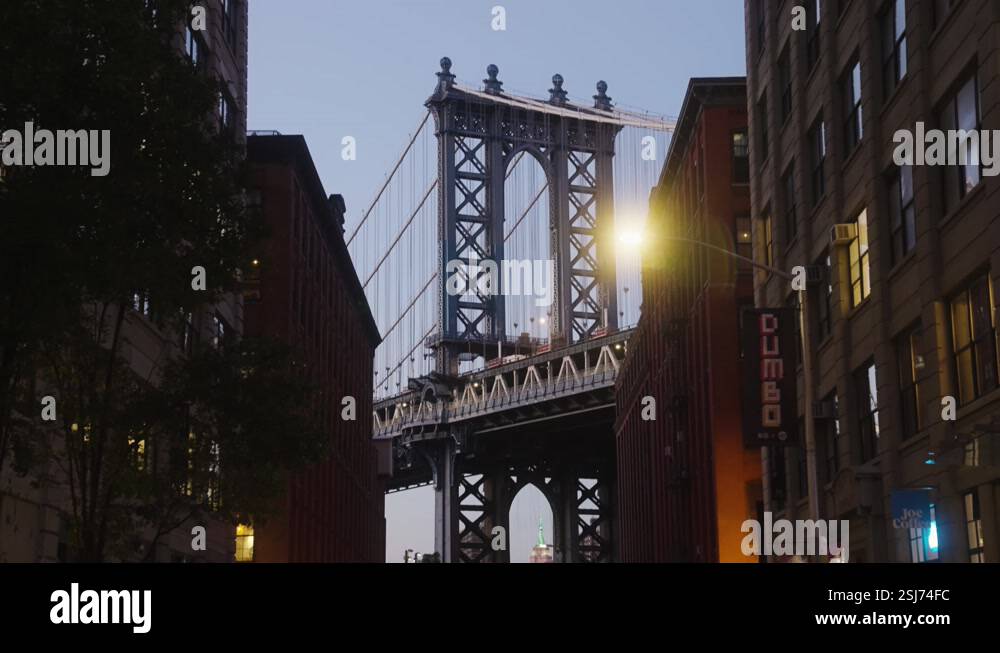 Bottom up shot of famous Manhattan Bridge during dusk in New York City ...