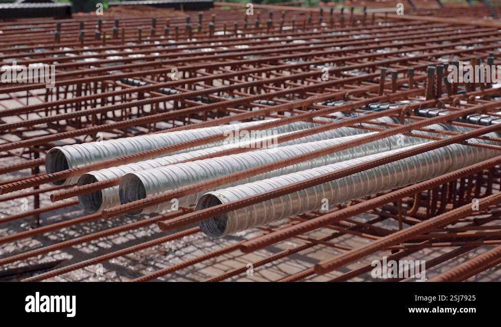 Metal reinforcing bars or rebar on a construction site waiting for the ...