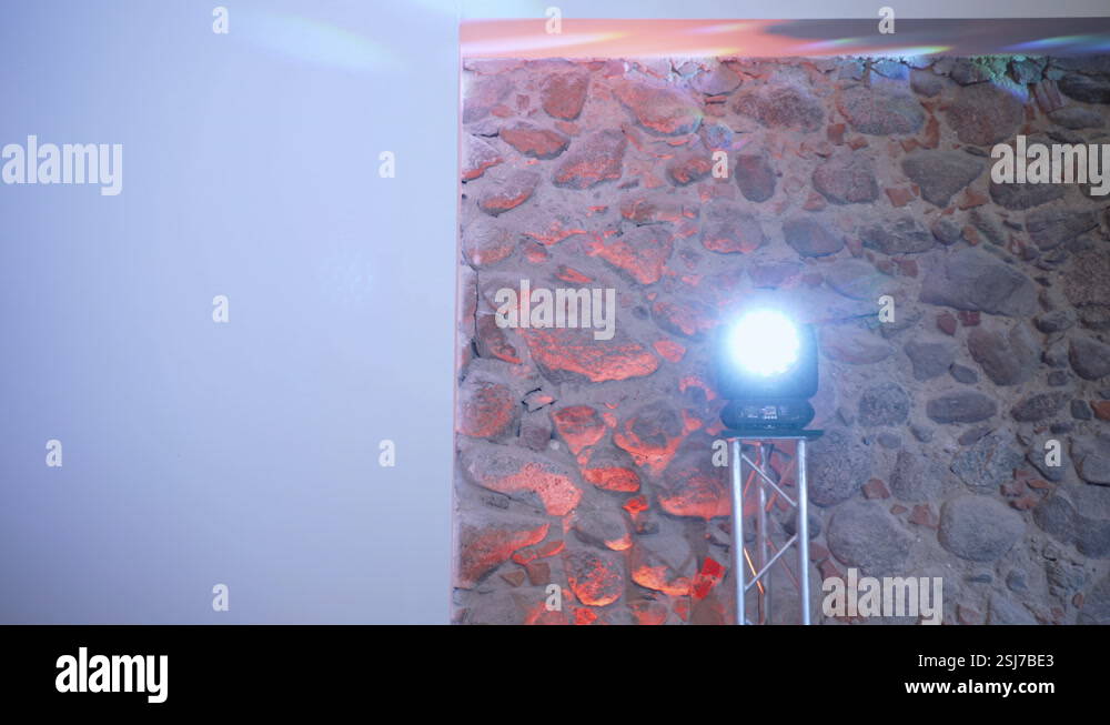 Professional LED controlled spotlight is mounted on metal frame near ...