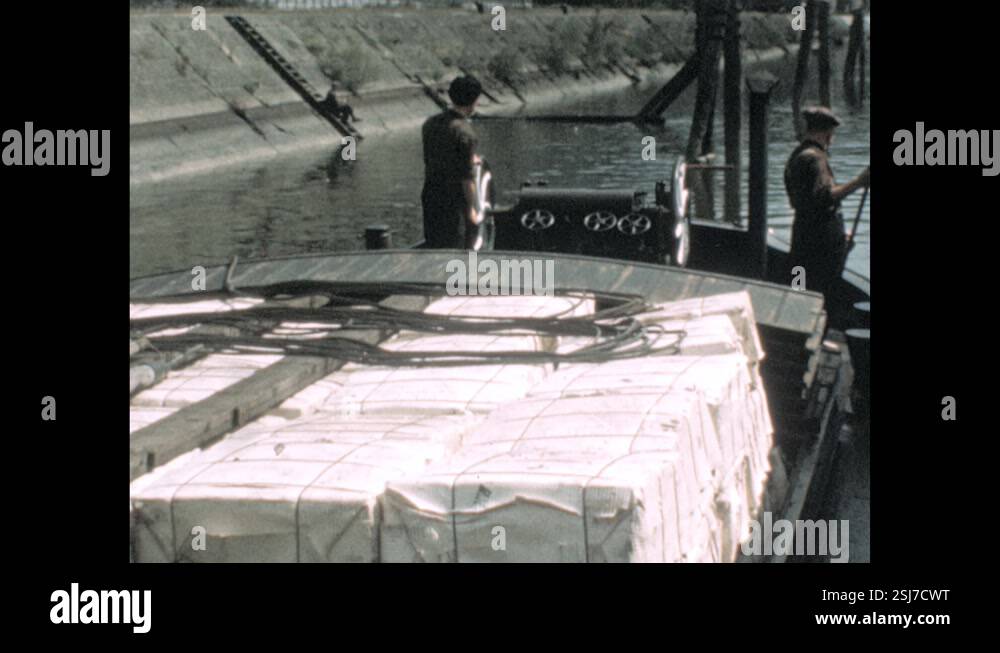 1950s: barges docked along river, barge sailing down river, cows on ...