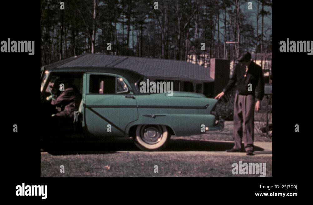 1950s: Car in a driveway. Slug. Young man checks the rear lights. Older ...