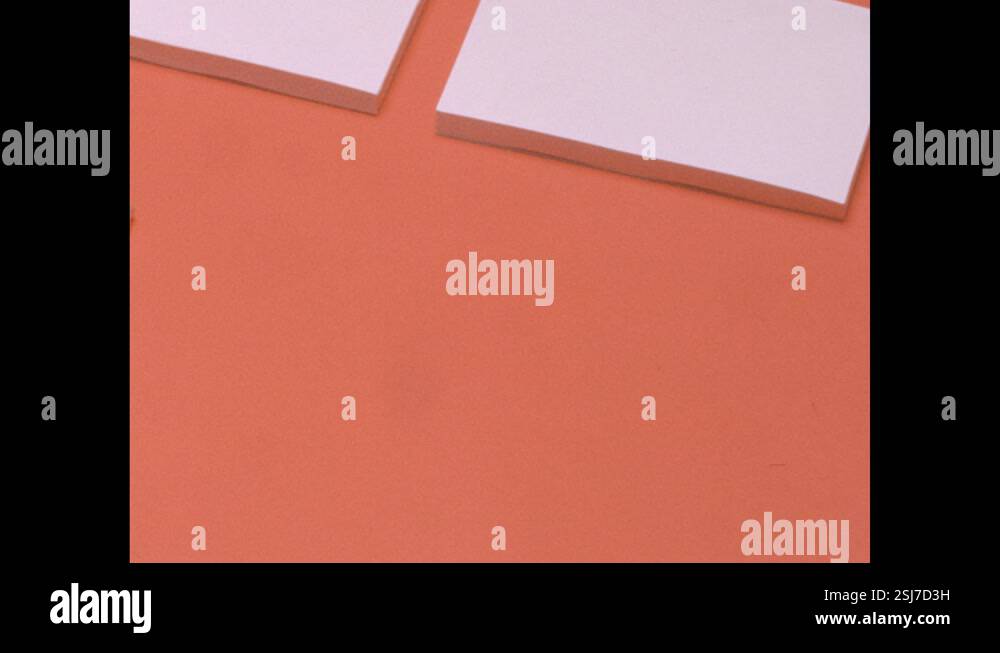 1960s: Pencil is placed under pad of paper on tabletop. Nine rubber ...