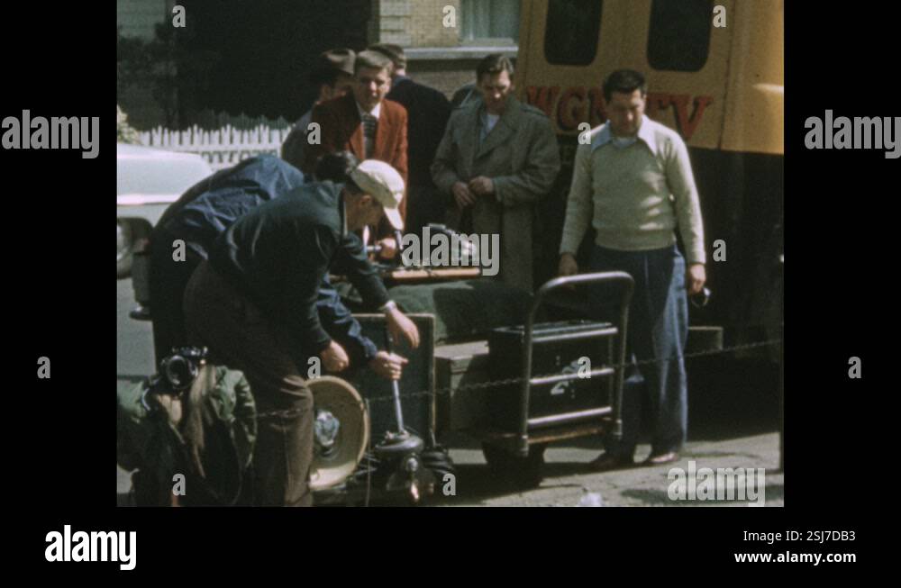 1940s: Men load things onto carts and pull. News truck pulls up to curb ...