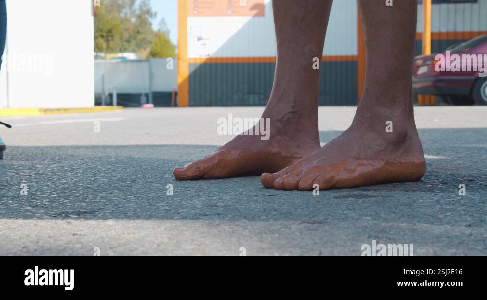 Close-up of a runner's wet feet, while taking a break from a marathon ...