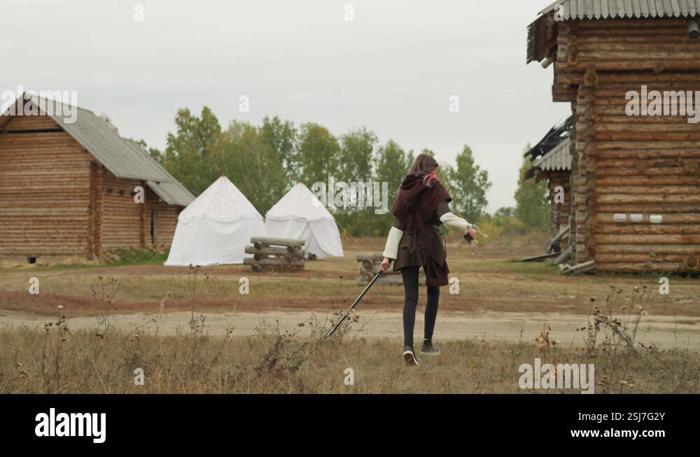 Girl rushes to medieval village after sword fighting Stock Video ...