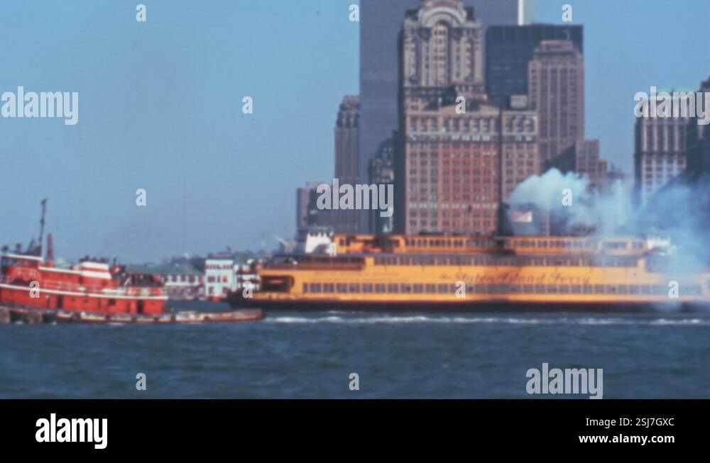 Tugboat tows cargo ship in New York Harbor. Manhattan skyscrapers in ...