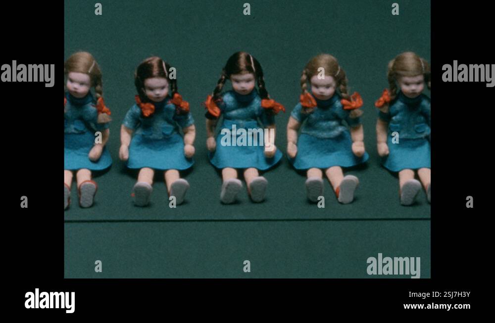 1960s: Five girl dolls sit on table. Five girl dolls and three boy ...