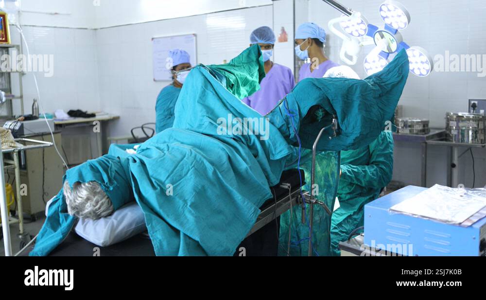 Team of experienced surgeons working together in an operation room ...