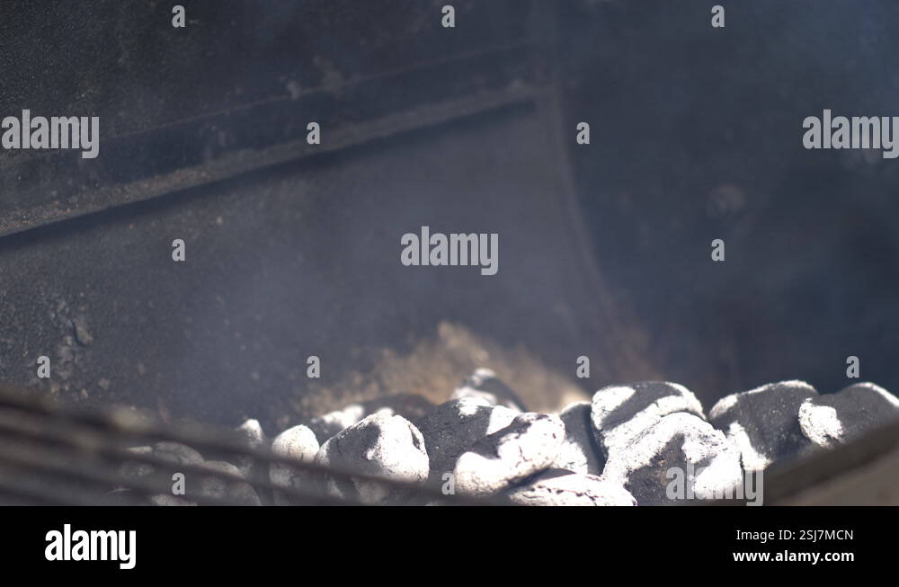 Charcoal burning and fire in slow motion in an offset smoker BBQ pit ...