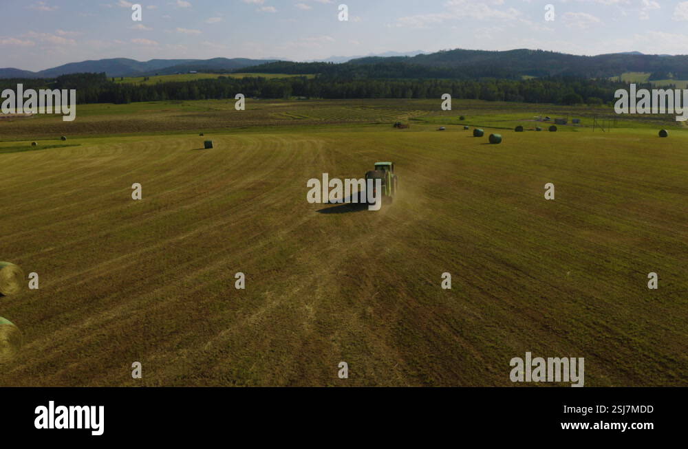 Agriculture and farming aerial view of tractors working in a field ...