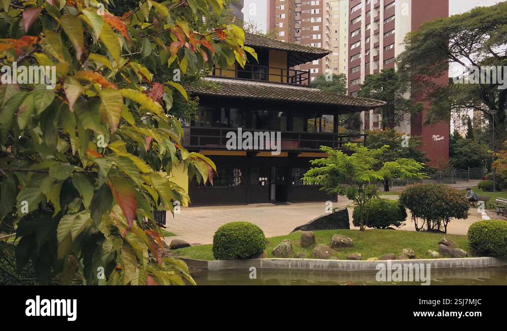 A traditional asiatic house amidst an exuberant city, surrounded by ...