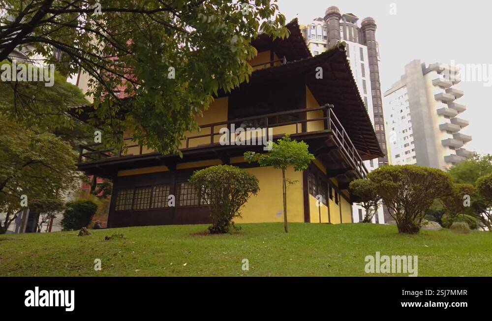 A traditional Japanese structure amidst an exuberant city, surrounded ...