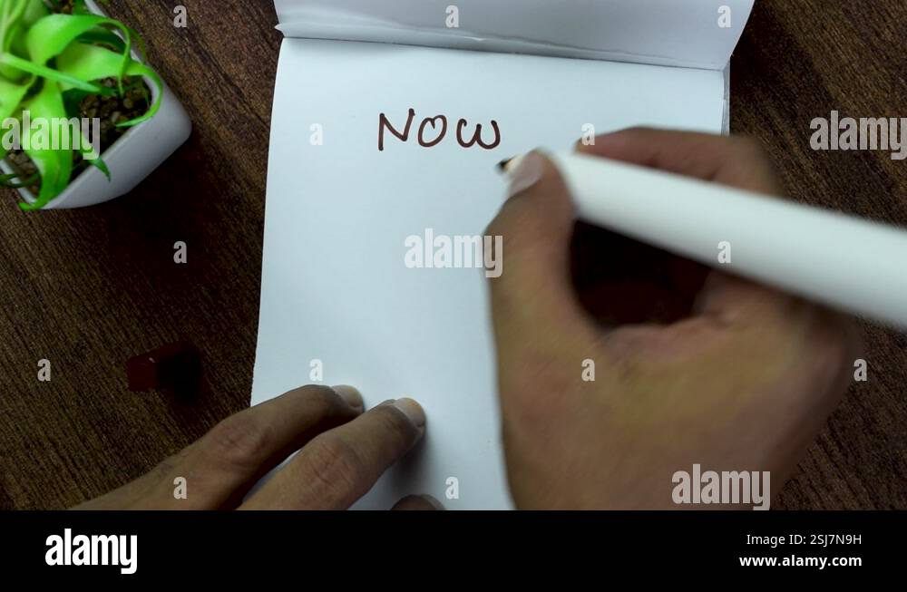 Concept of Now or Never write on book isolated on Wooden Table Stock ...