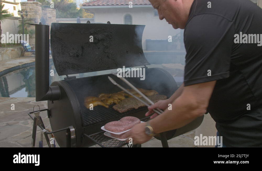 Man opens BBQ pit and puts sausage on to grill Stock Video Footage - Alamy