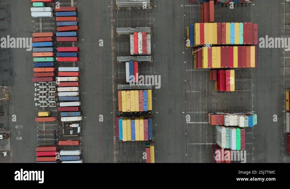 Top down aerial view of shipping containers sitting in a port, waiting ...