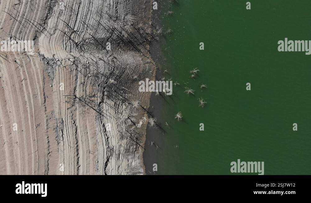 Empty reservoir. Aerial shot. Drought. Cracked ground. Zenital shot ...