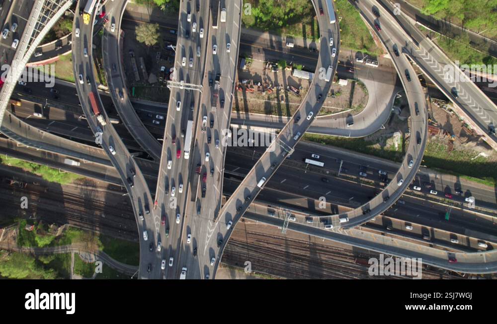 Overhead aerial of crazy traffic interchange with bridges, ramps, rush ...