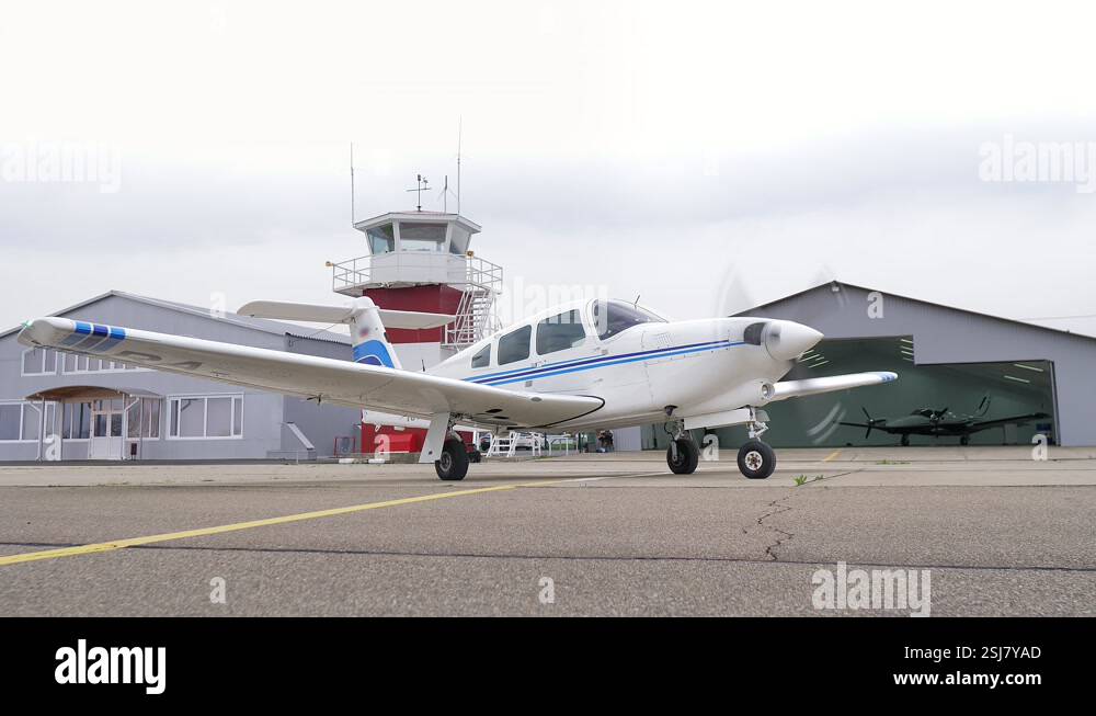 Single engine propeller airplane is standing in front of a closed ...