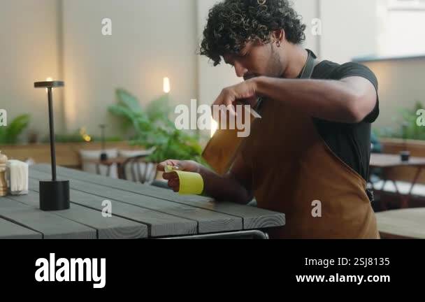 Upset sad Indian Arabian latino man waiter in apron guy cleaner cafe ...