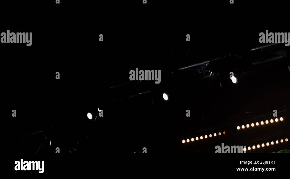 flashing and rotating light beams from stage lights on a construction ...