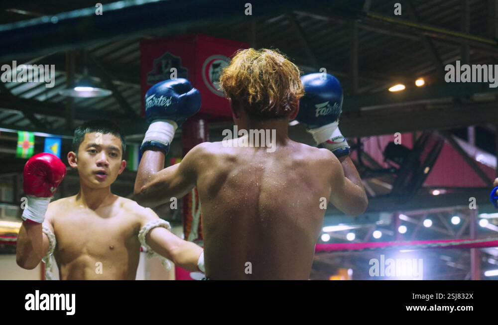 4K Cinematic slow motion footage of two young Thai men fighters on a ...
