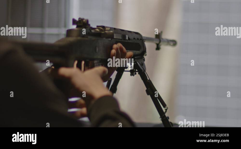 Shooter grabbing Ruger Mini-14 Rifle and aiming the weapon down range ...