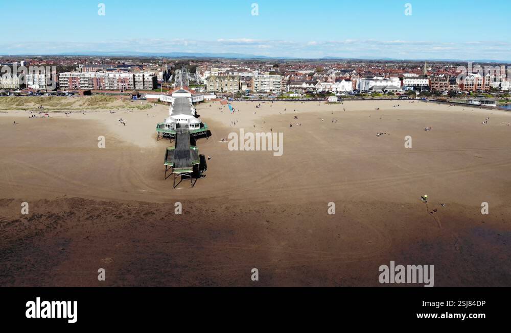 Raising up rotating to reveal the Lytham St Anne's beach at low tide on ...
