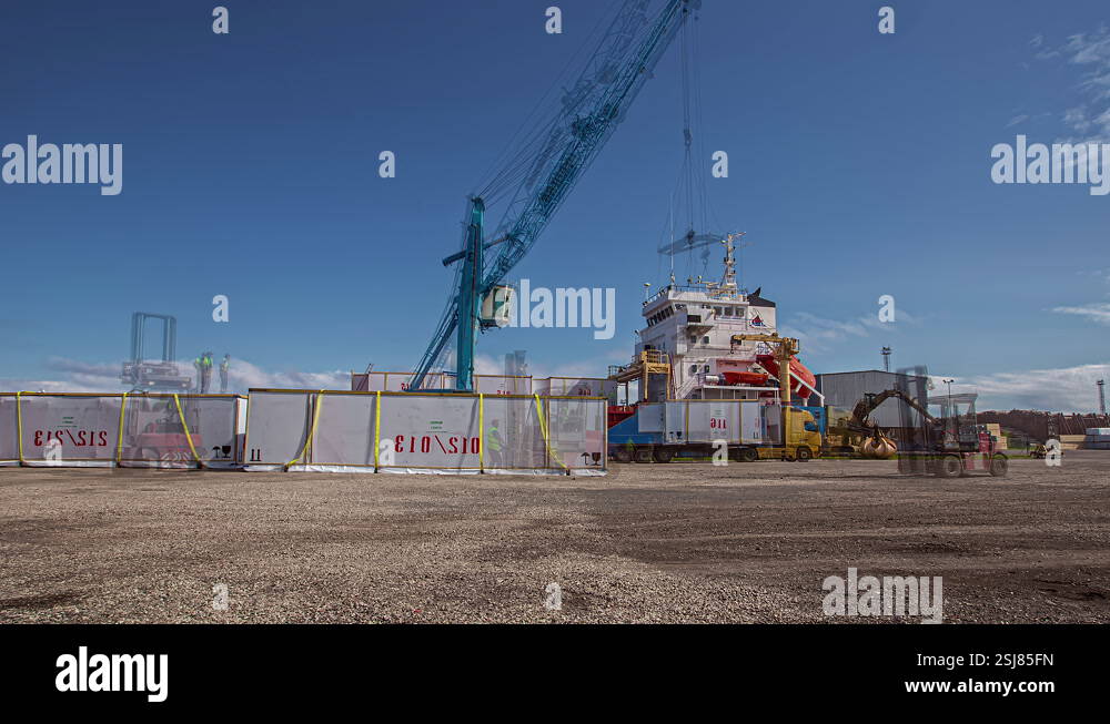 Timelapse of large crane loading shipping containers onto barge for ...