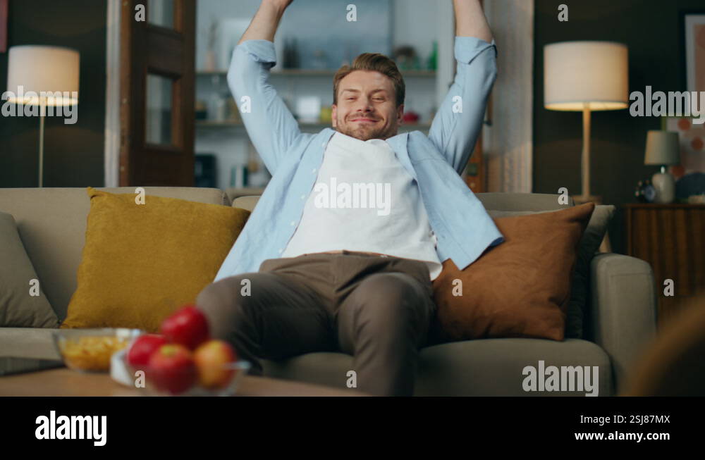 Handsome guy chilling couch cozy living room. Carefree man relaxing in ...