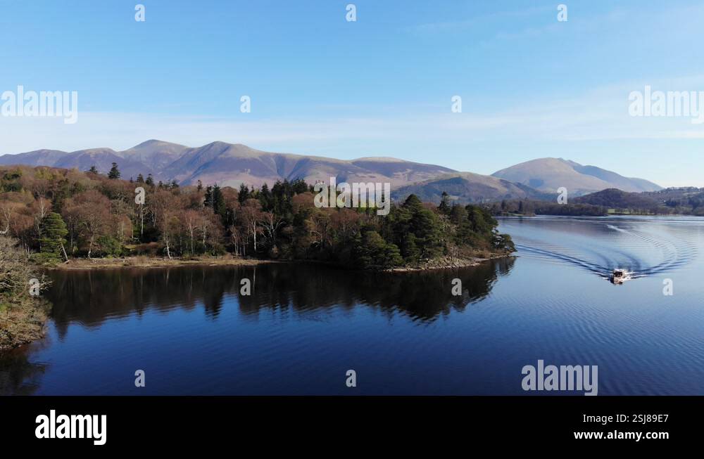 Static aerial shot from above the water as a boat approaches Hawes End ...