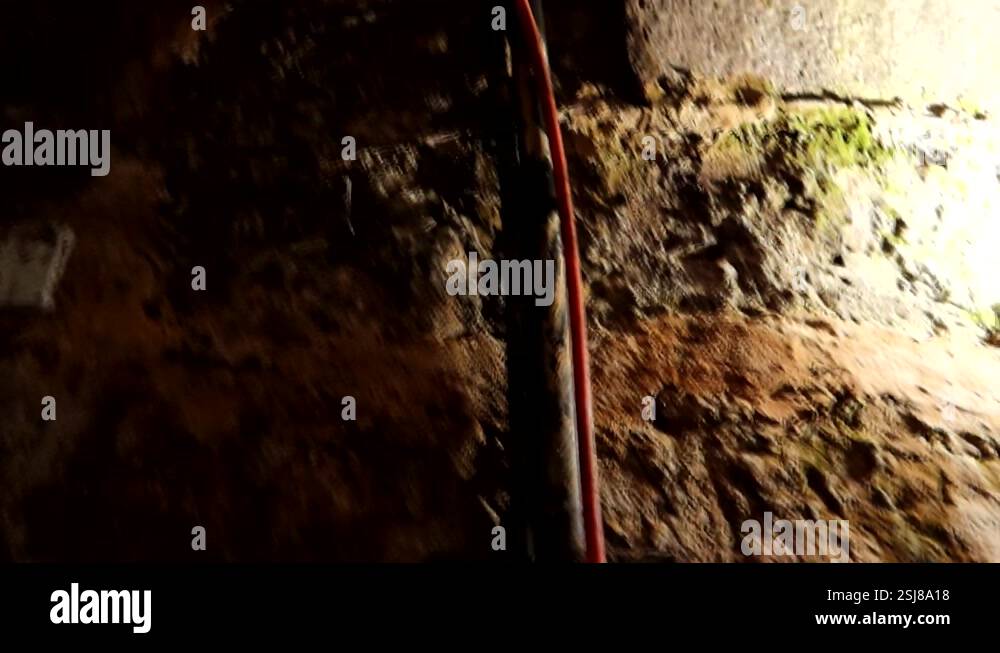 Woman shows where an air shaft is located inside of a wine cellar in ...