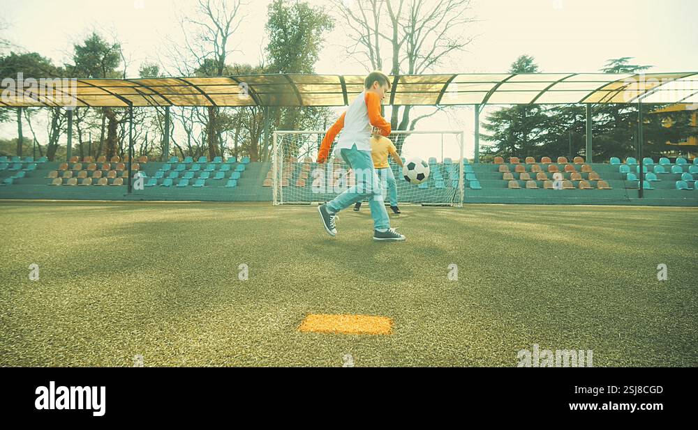 Father and Son play football on stadium, Happy family outdoors, bonding ...