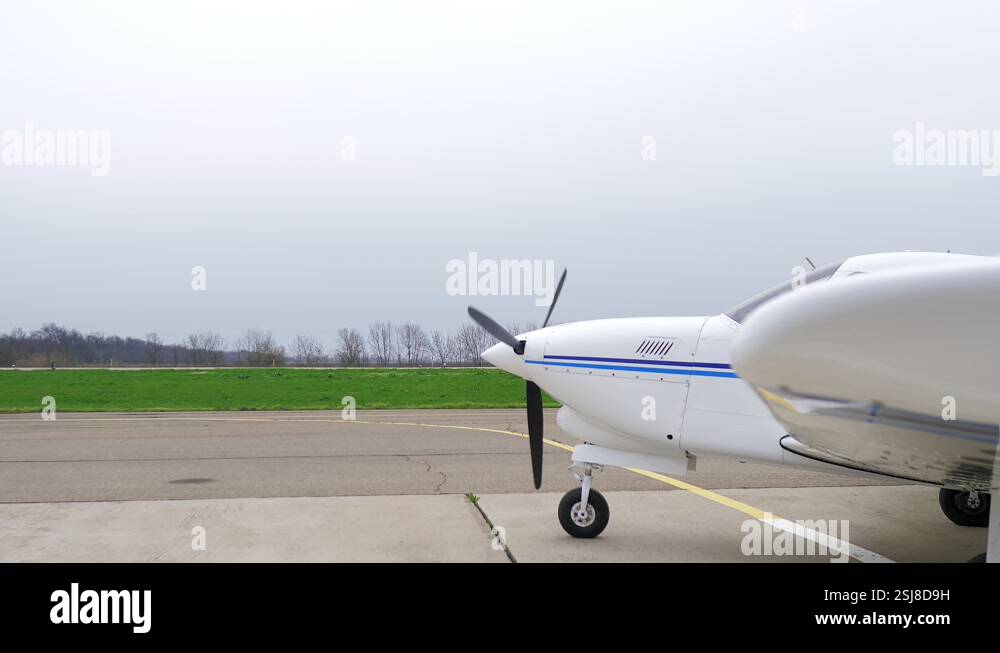 Single engine propeller airplane is standing in front of an airstrip ...