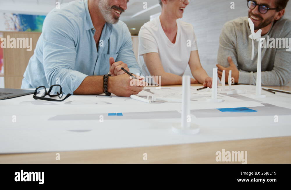 Teamwork in a mechanical engineering office: Three business people ...