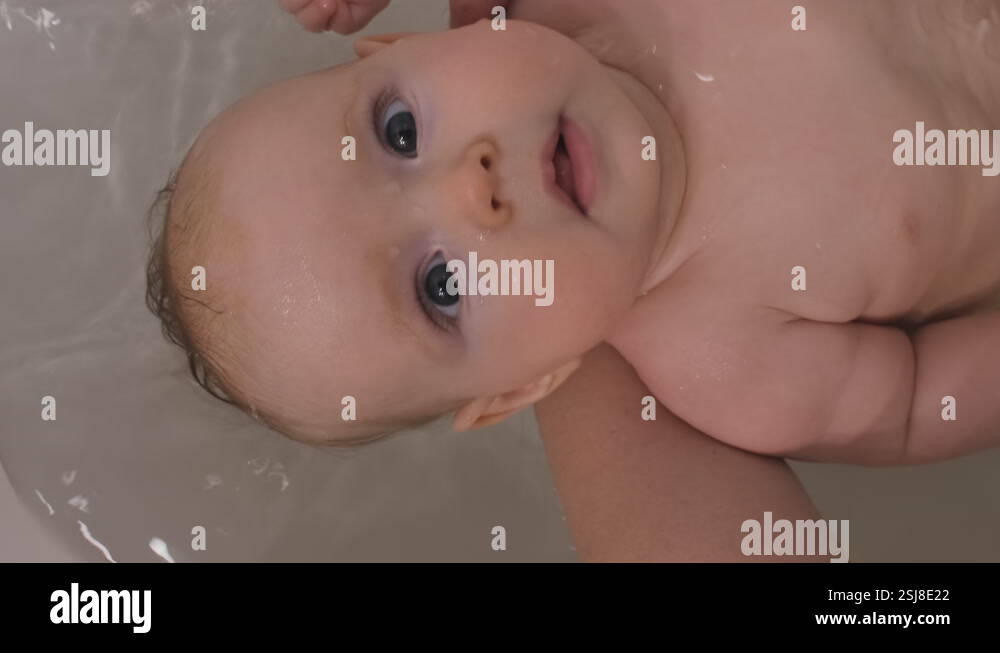 Cute baby girl bathing in plastic tub Stock Video Footage - Alamy