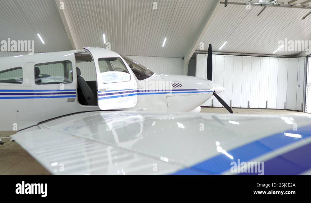 Side view of single engine propeller airplane standing in a closed ...