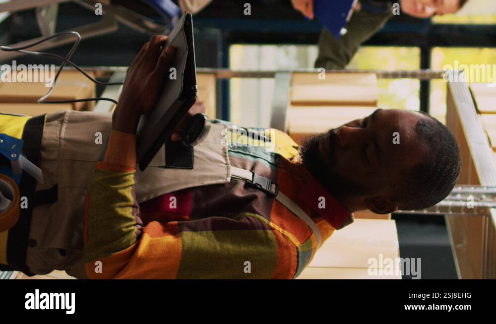 Vertical video: Young person scanning barcodes in depot Stock Video ...