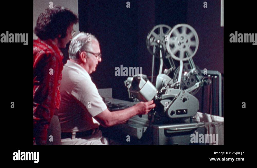 1970s: Woman at copy machine, zoom in. Hand working sound board. Man ...