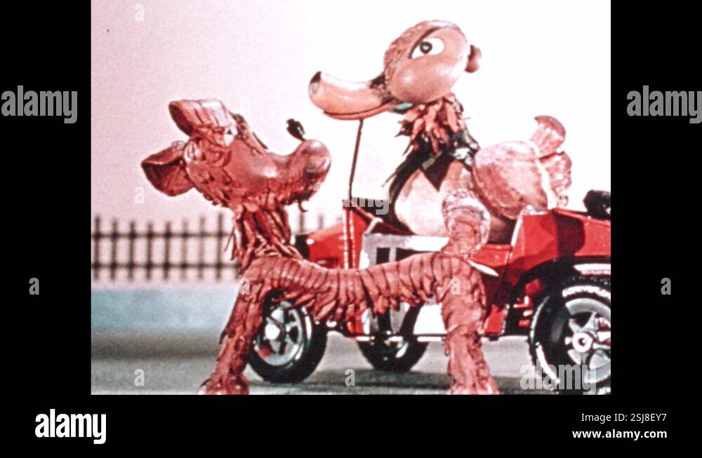 1970s: Stop motion dog catches cat in net. Cat runs away. Dog looks at ...