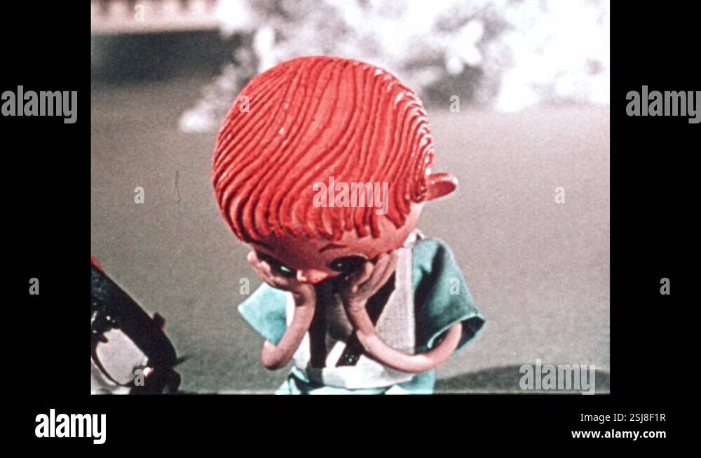 1970s: Stop motion broken wheels on derby car. Boy removes helmet, puts ...