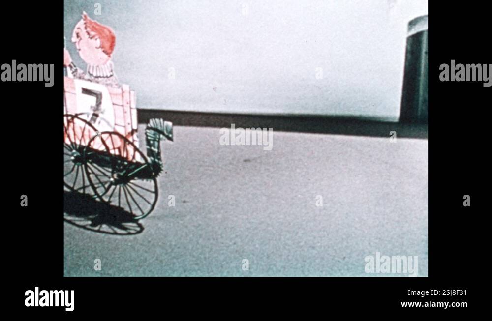 1970s: Stop motion duck waves goodbye to boy on derby car. Boy drives ...