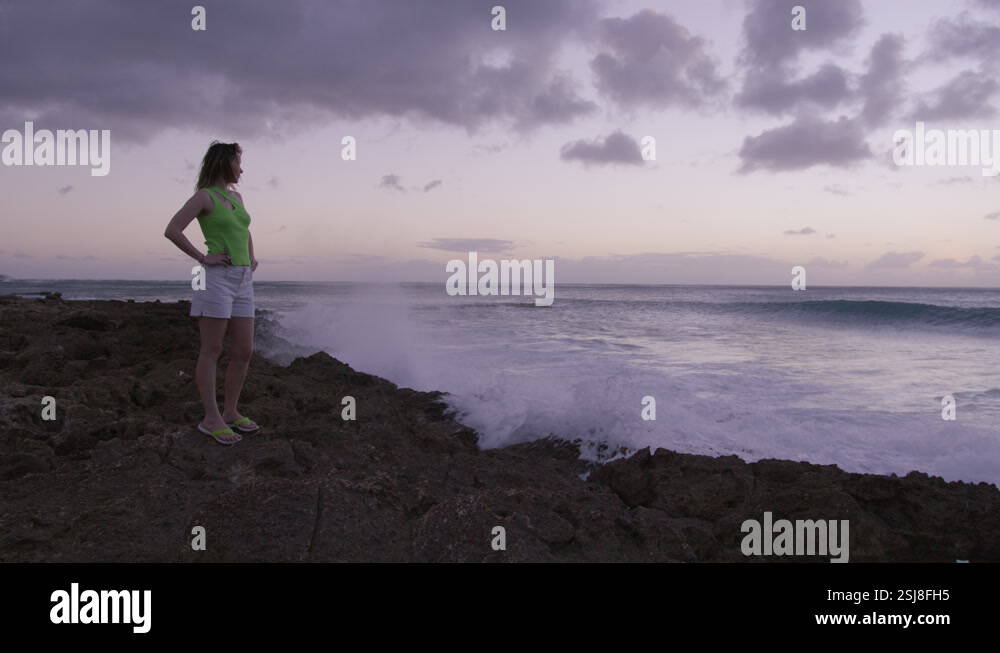 Traveler at Beautiful blue sea and large calm waves float on rocky ...