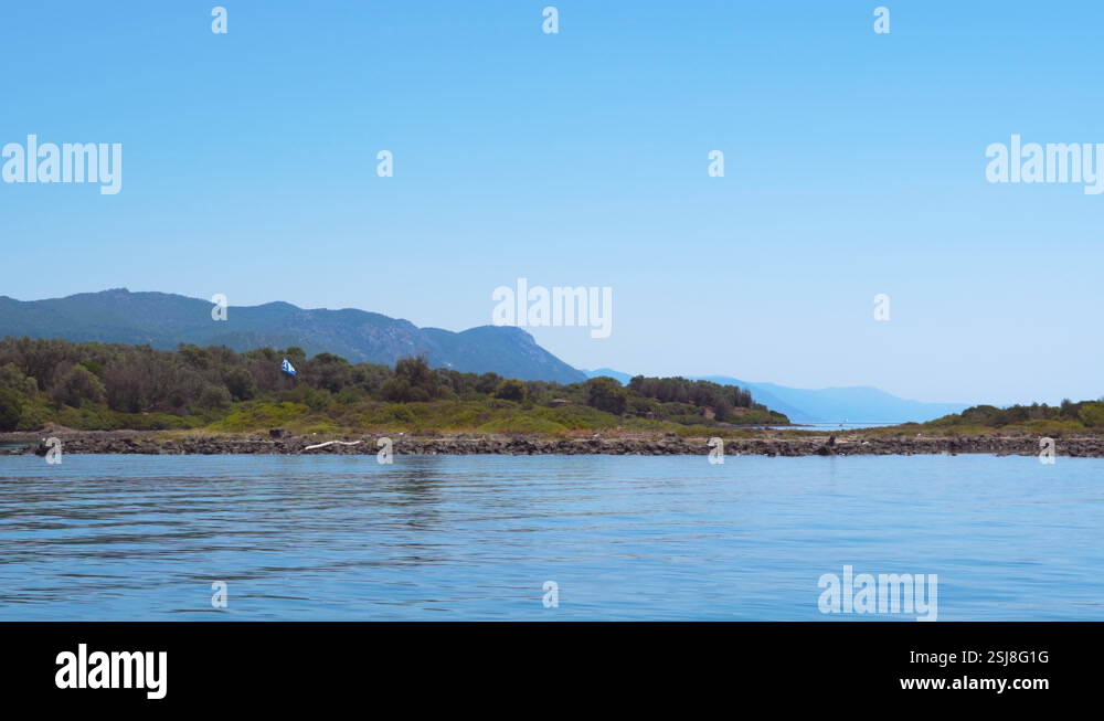 Sailing ship day side POV view looking to a rocky coastline island ...