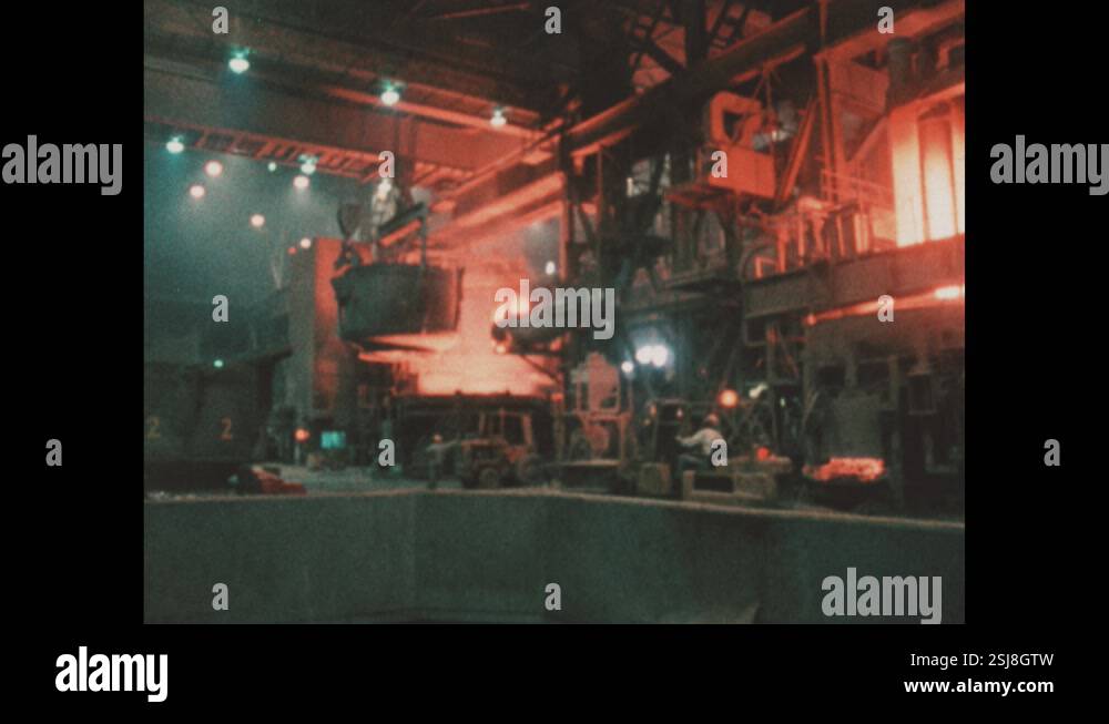 1980s: Aerial view of highway. Mill interior. Man at controls. Liquid ...