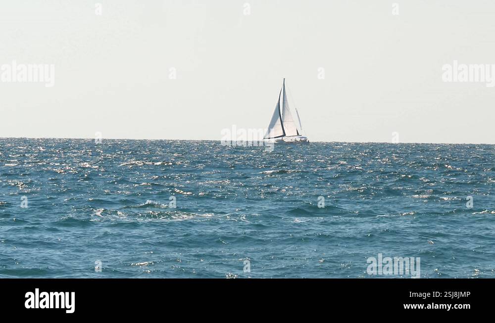 Sailing yacht floats on waves in open sea during day. Sea travel ...