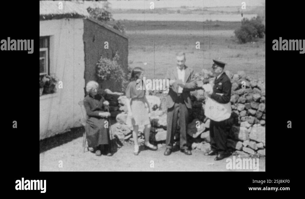 1940s: man opens envelope as mailman, girl and seated woman watch, man ...