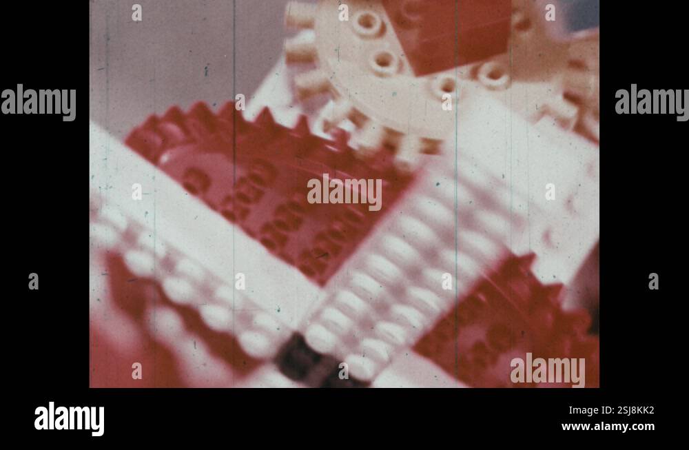 1970s: Elaborate Lego machine slows, gears stick, smoke rises, girl ...