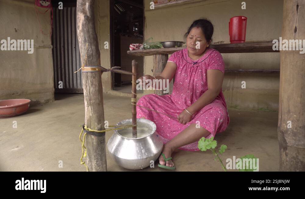 A woman making butter at home in ancient ways Stock Video Footage - Alamy