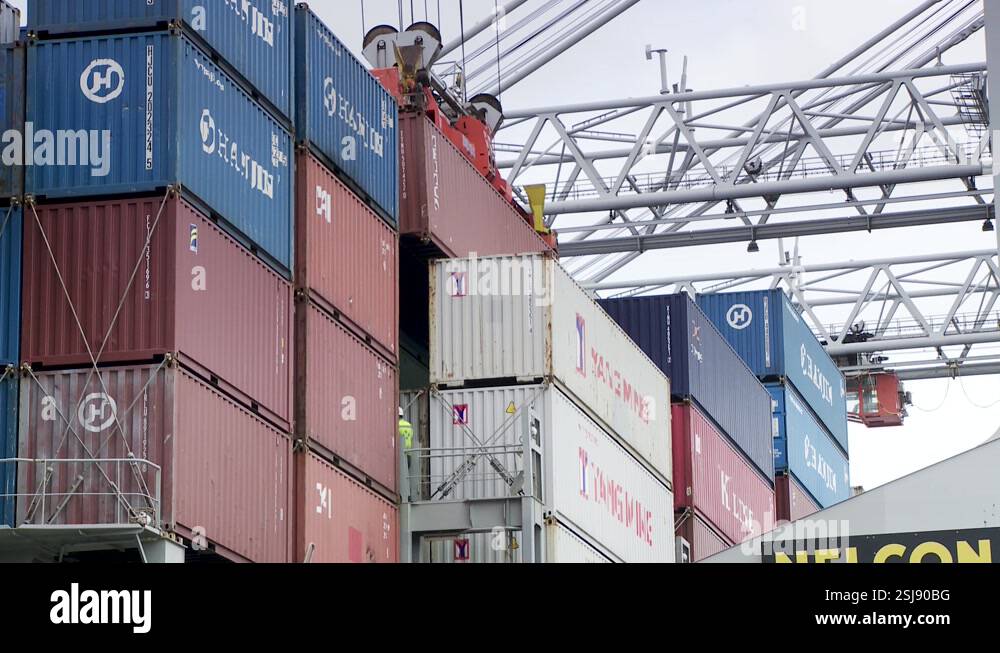 Harbour crane loads a red container to a big freight vessel on logistic Stock Video Footage - Alamy